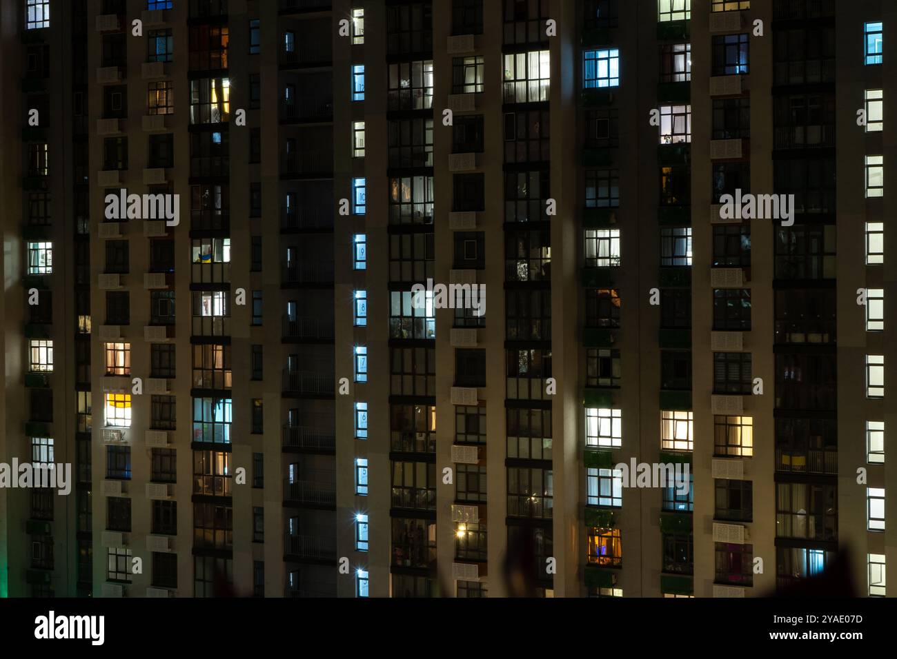 Night big city light residential building. The windows of the house ...