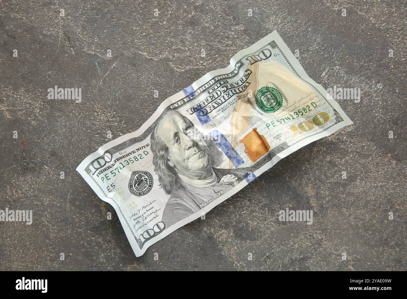 One crumpled dollar banknote on grey table, top view Stock Photo - Alamy