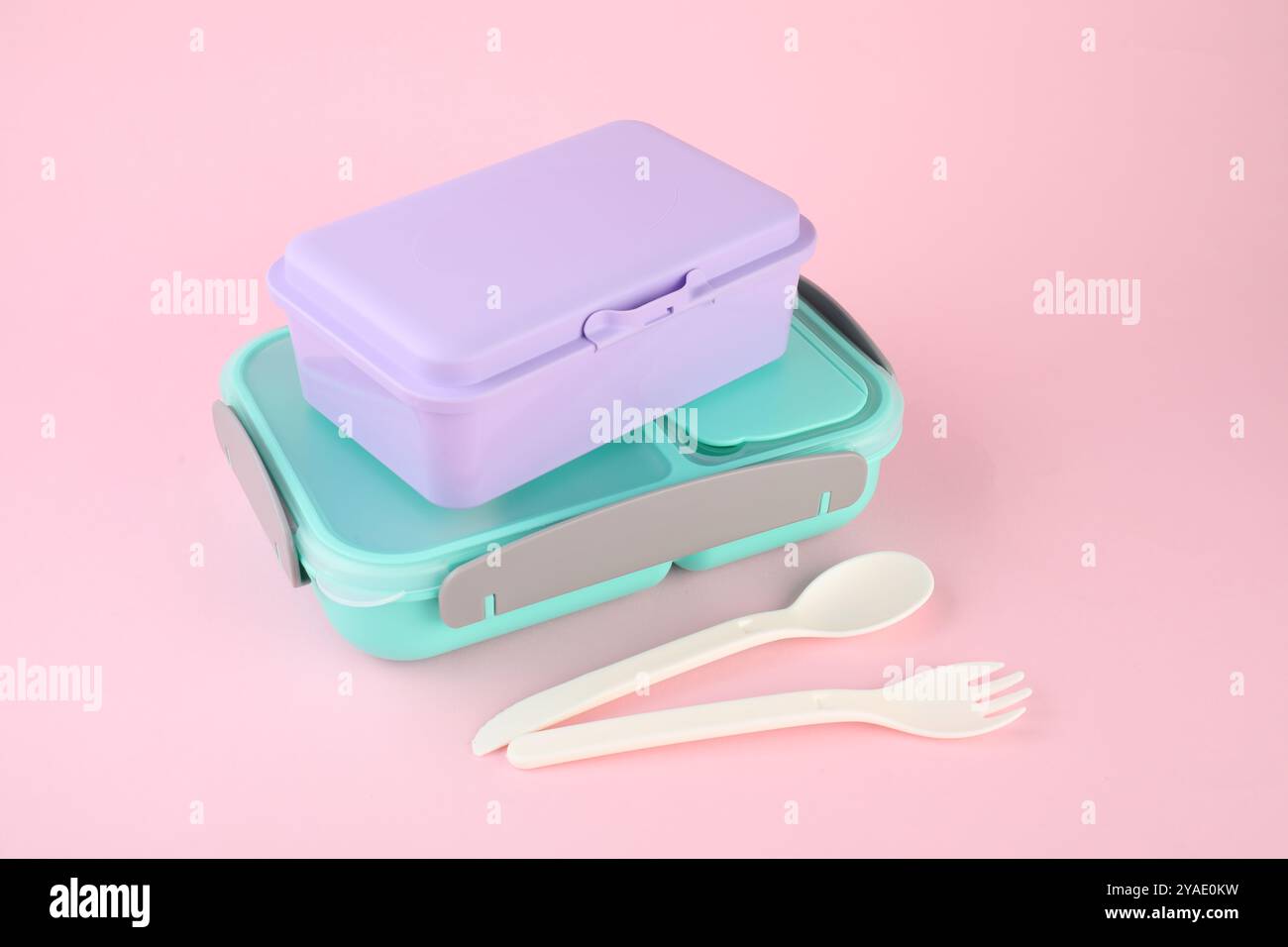 Two plastic lunch boxes with cutlery on light pink background Stock ...