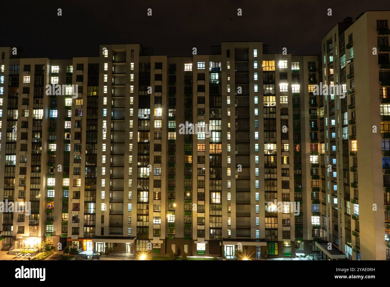 Night big city light. Multi storey residential building. Windows house ...