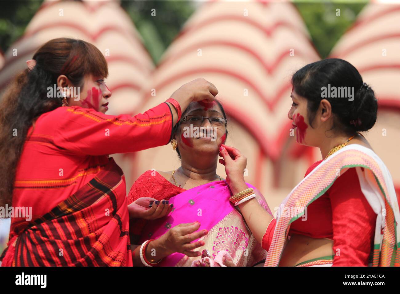 Dhaka, Wari, Bangladesh. 13th Oct, 2024. Devotees take part in a ritual 'Sindoor Khela' wherein ...
