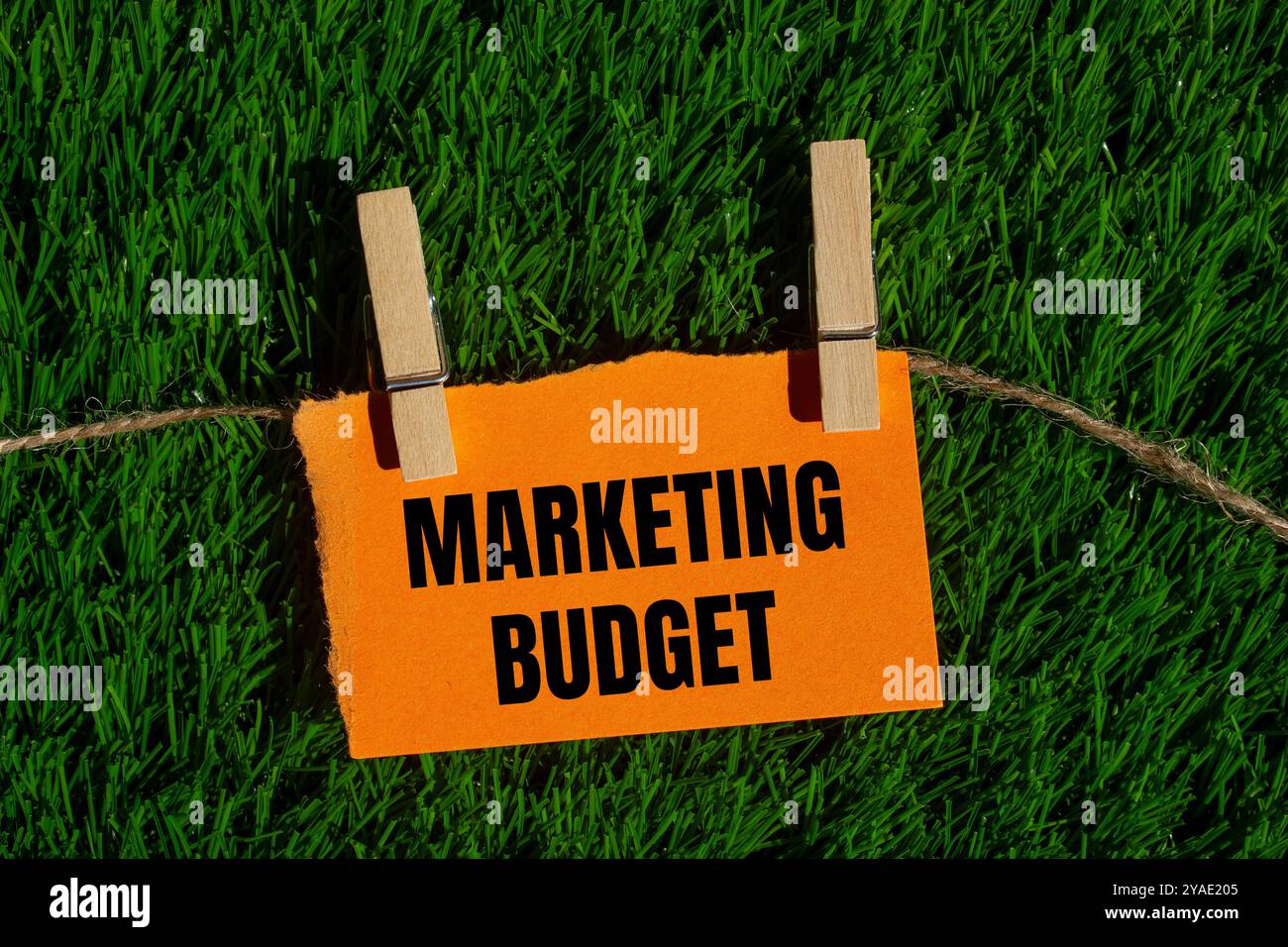 Marketing budget message written on ripped torn orange paper piece with ...