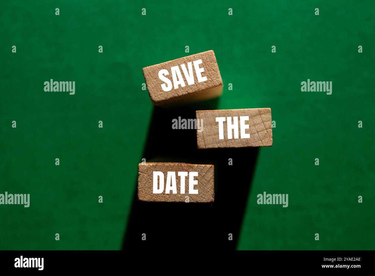 Save the date message written on wooden blocks with green background ...