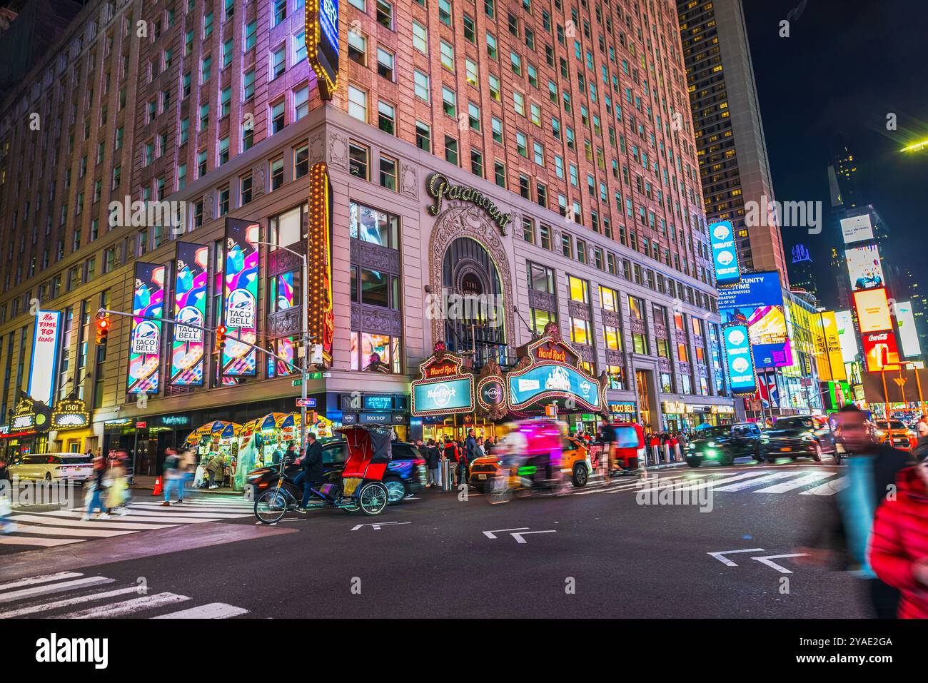 Busy intersection at night in Times Square with illuminated Hard Rock ...