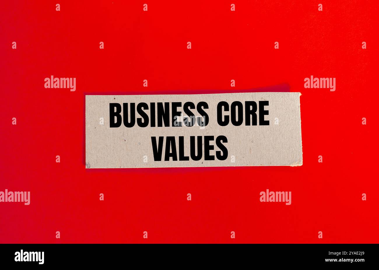 Business core values message written on paper piece with red background ...
