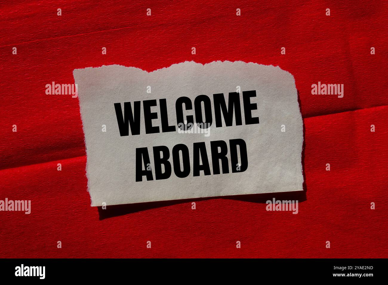 Welcome aboard message written on ripped torn paper piece on red ...