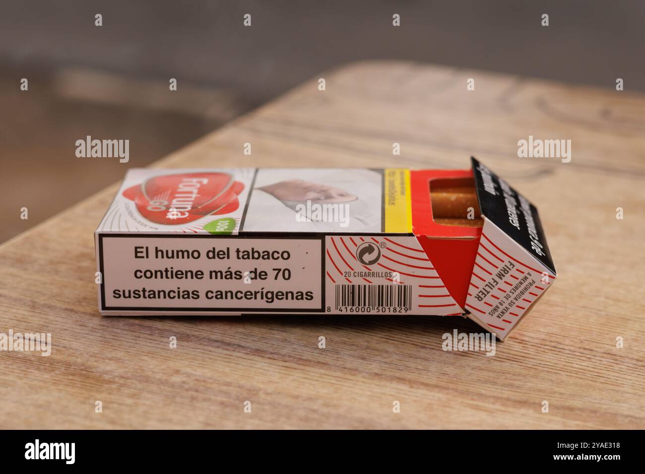 Fortune cigarette pack on bar table and legend about the health danger ...