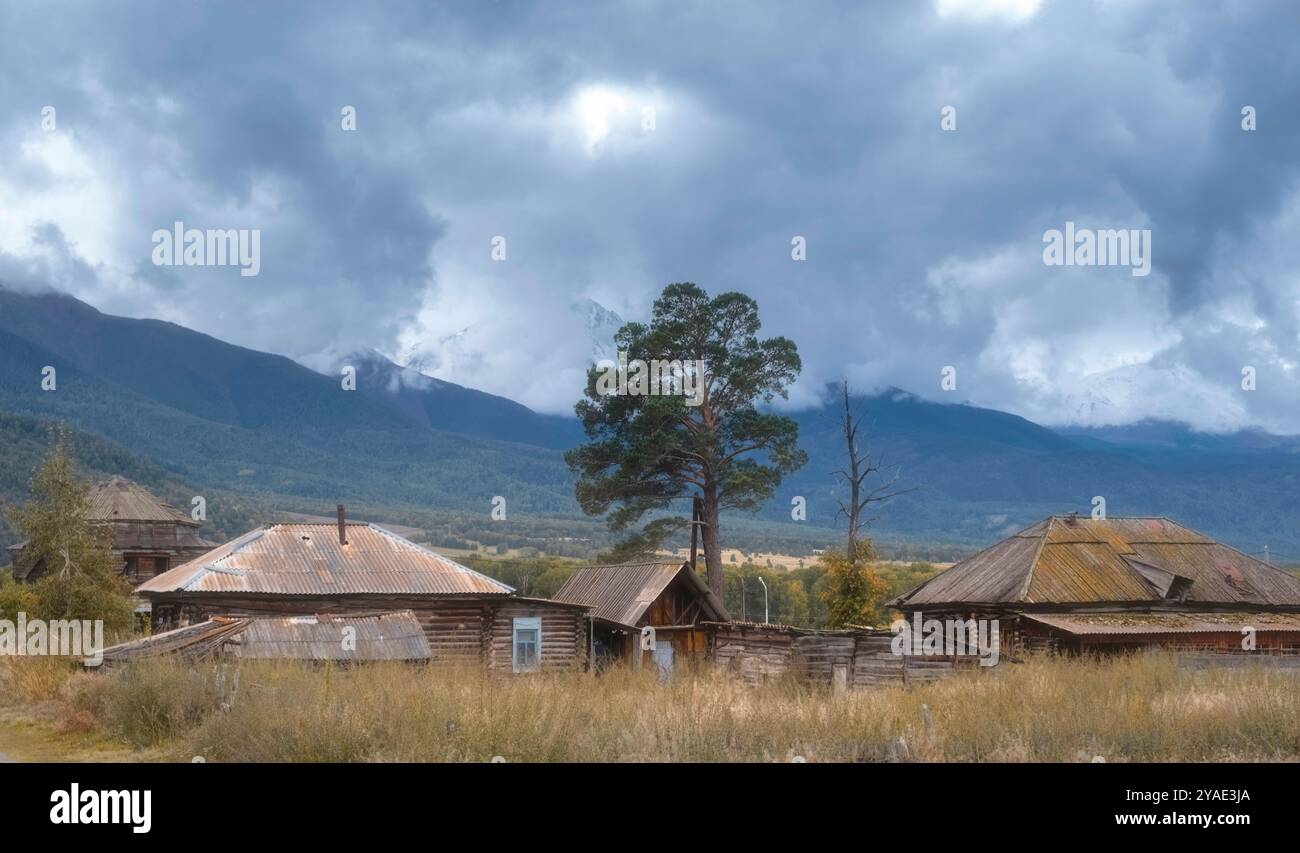 Old wooden houses, fences and an abandoned church in the mountain ...