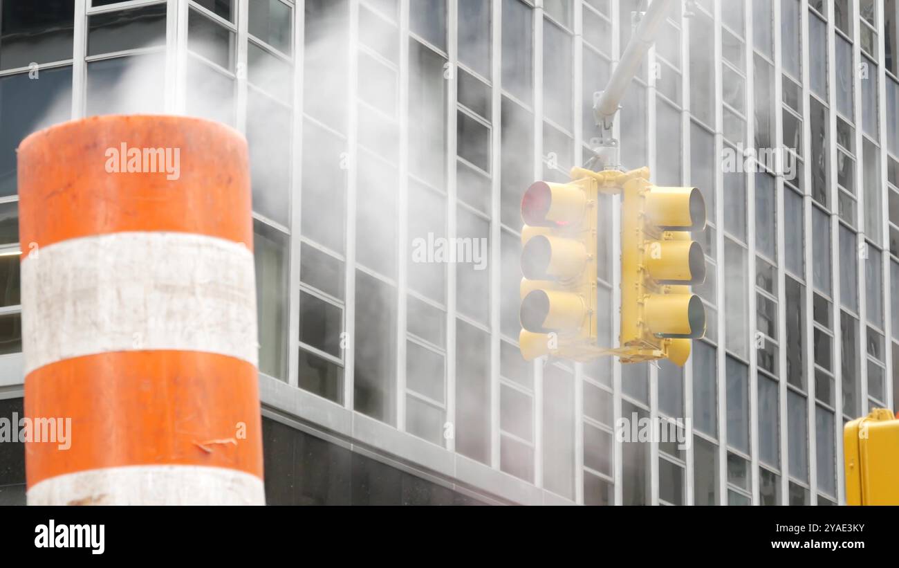 Steam vapor vented on New York City Water street, orange vapour tube ...