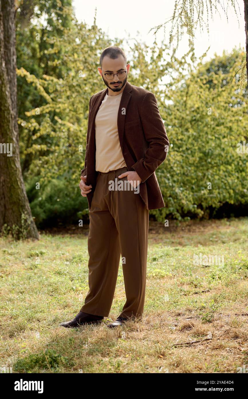 Handsome man dressed in autumn attire pose confidently amidst the ...
