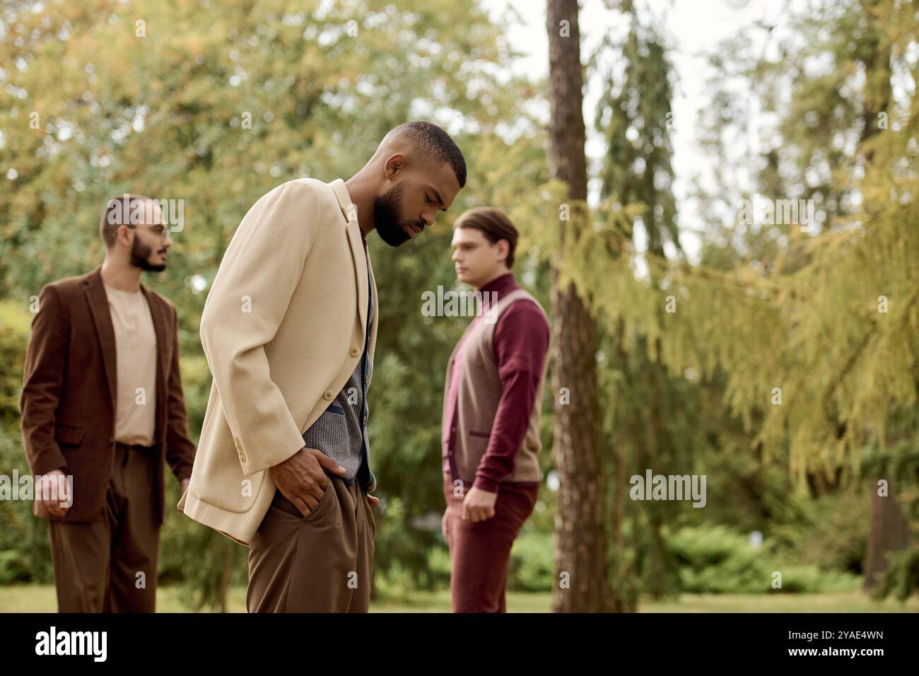 Three men exude charm and elegance while posing in a stunning autumn ...