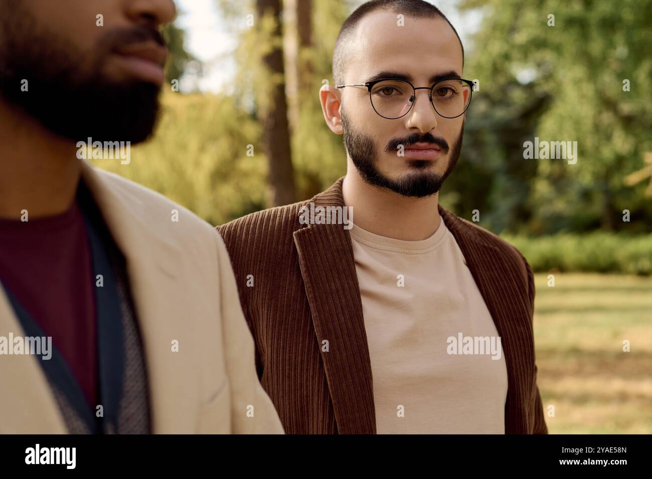 Two handsome men showcase their fashionable autumn outfits amidst a ...
