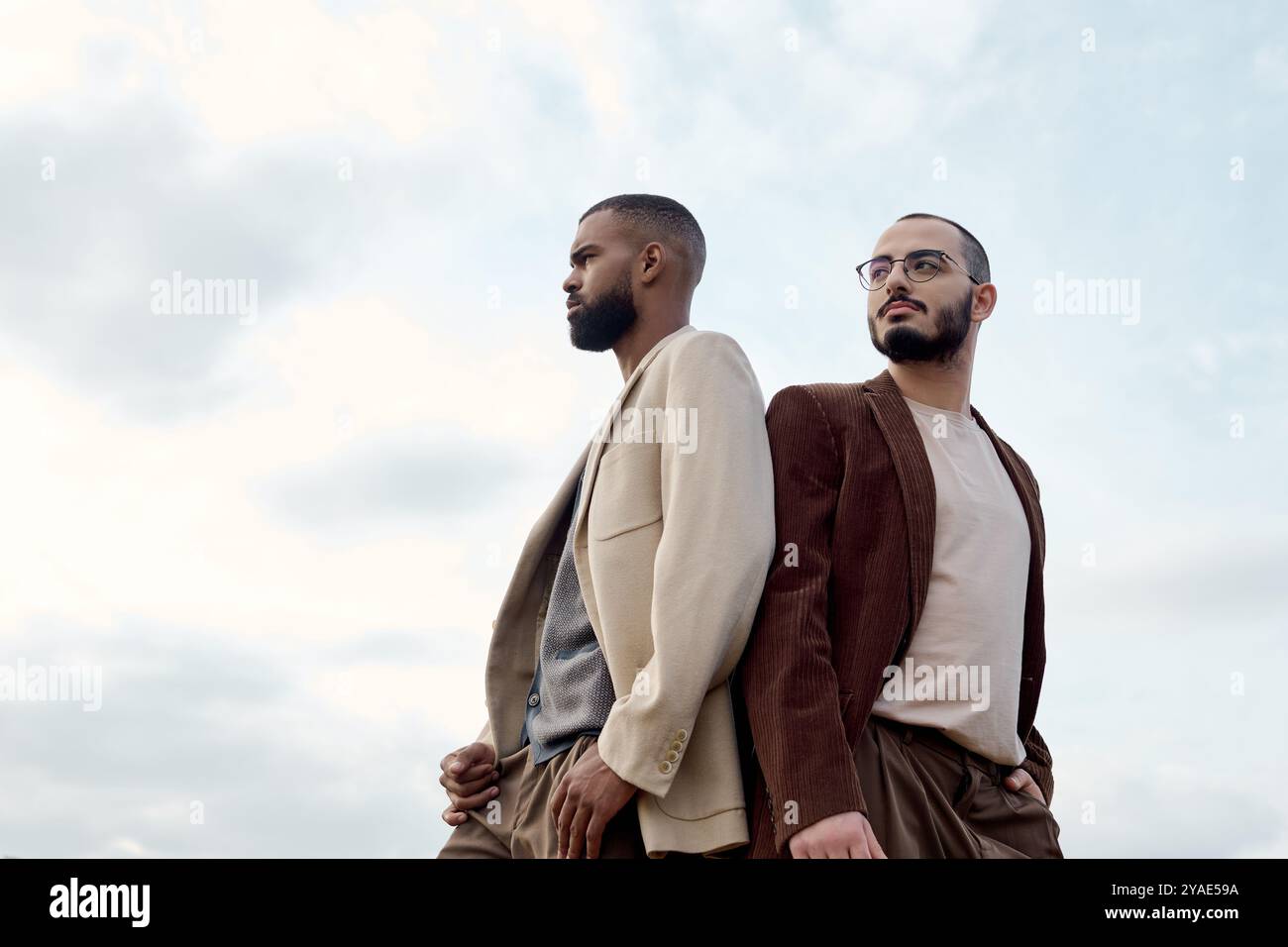 Two handsome men showcase autumn fashion while enjoying the serene ...