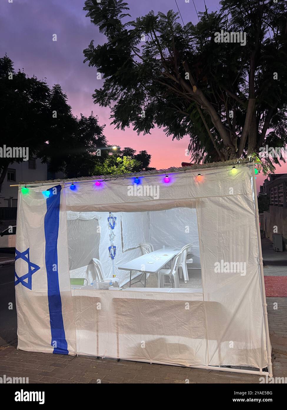 A decorated Sukkah set up on the street for the Jewish holiday of ...