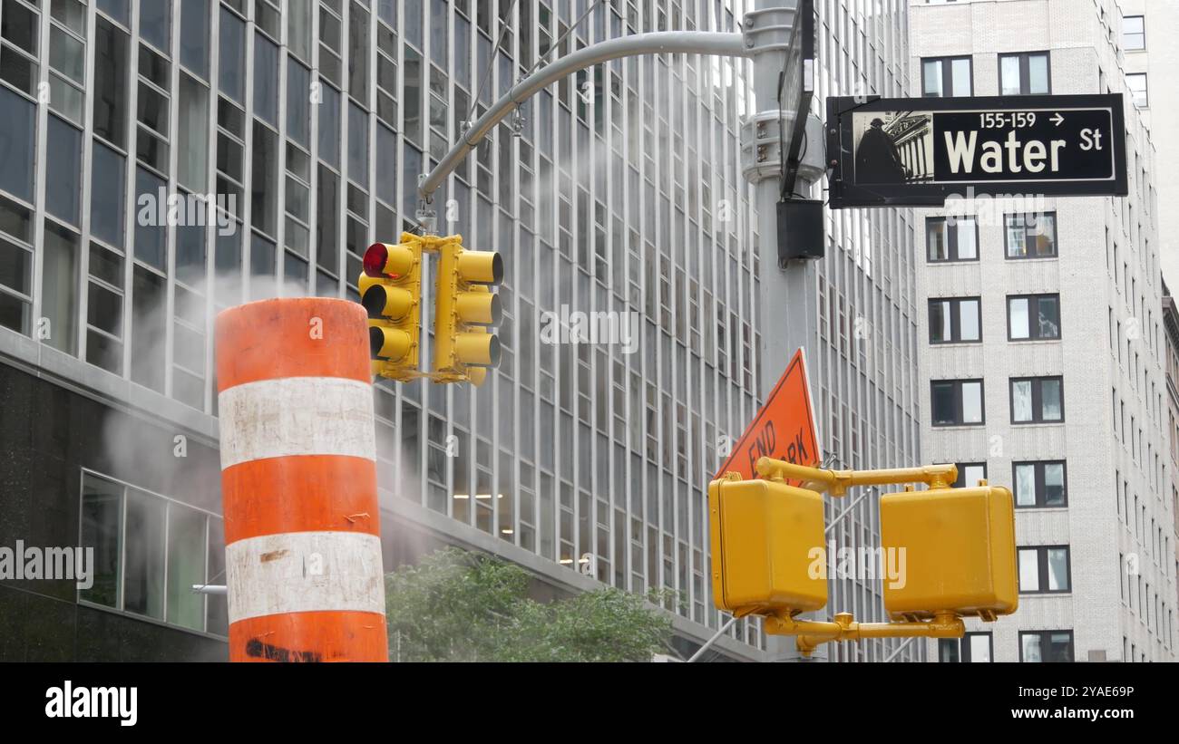 Steam vapor vented on New York City Water street, orange vapour tube ...