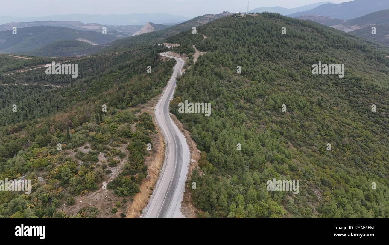 Vertical aerial photo overcast weather, asphalt road over the mountain ...