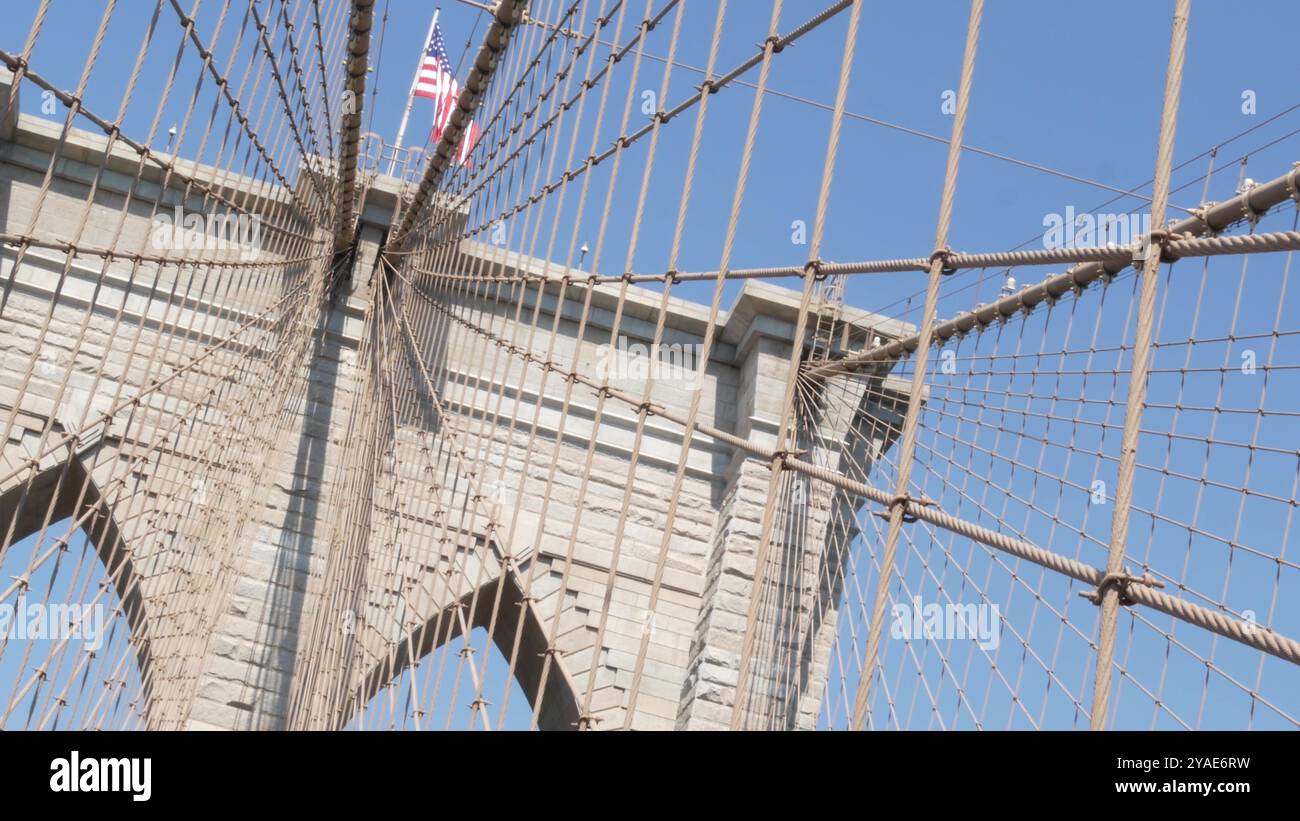 Brooklyn Bridge to Manhattan downtown, cables and blue sky. New York ...