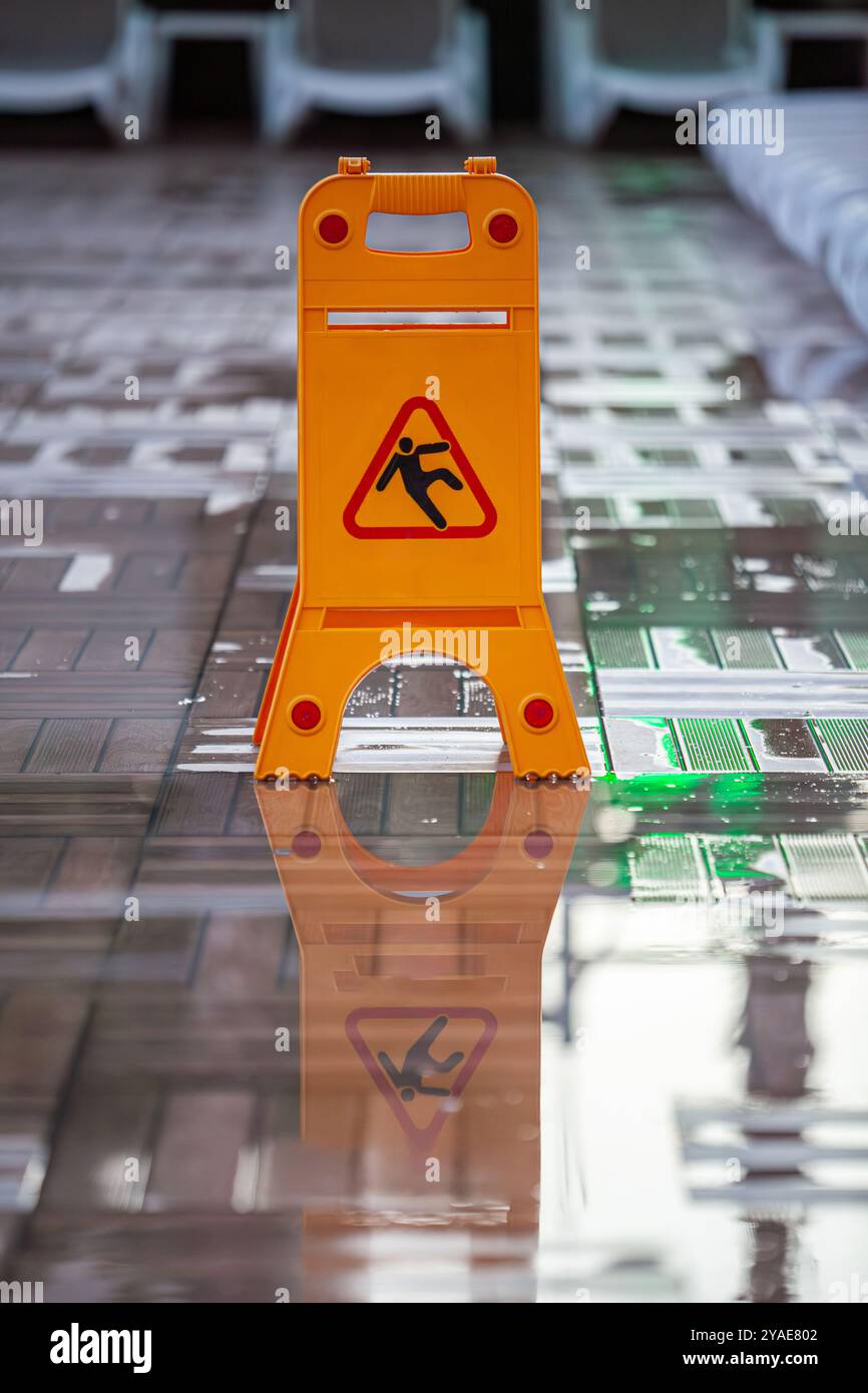 Caution wet floor warning sign near swimming pool in hotel Stock Photo ...