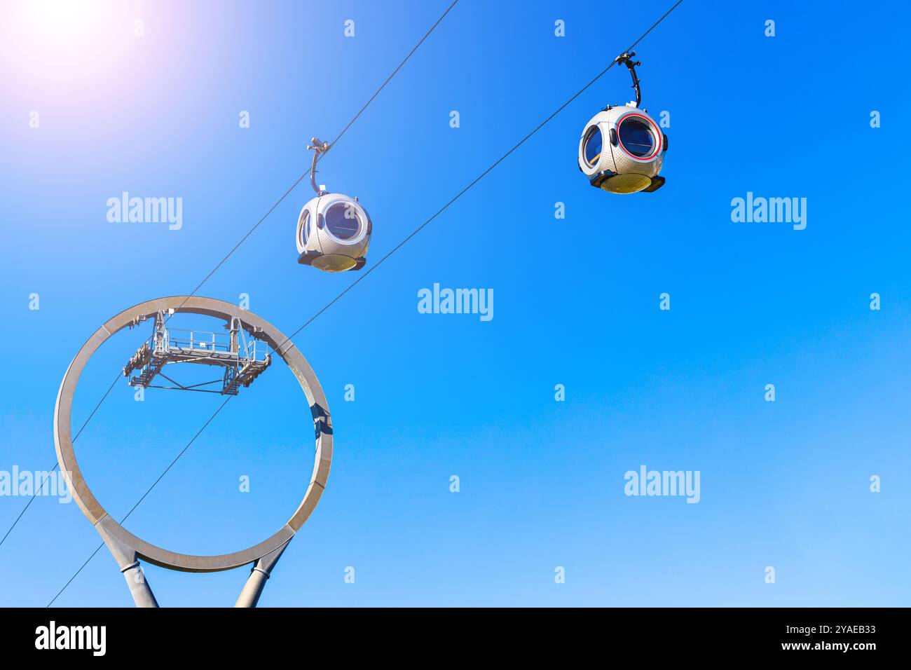 a cable car with round passenger cabins. cable car against blue sky ...