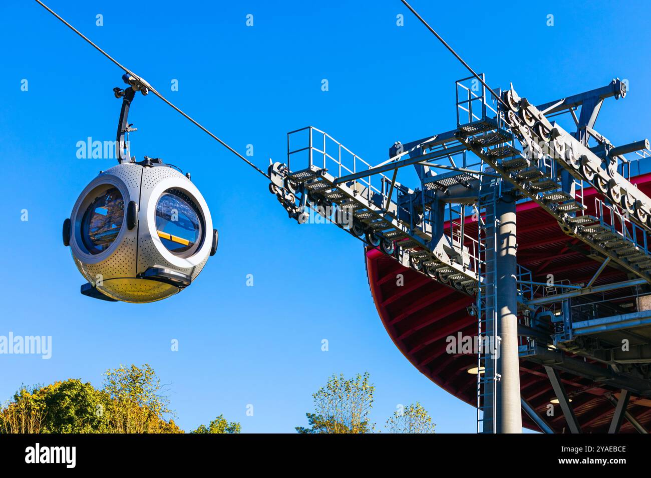 a cable car with round passenger cabins. cable car against blue sky ...