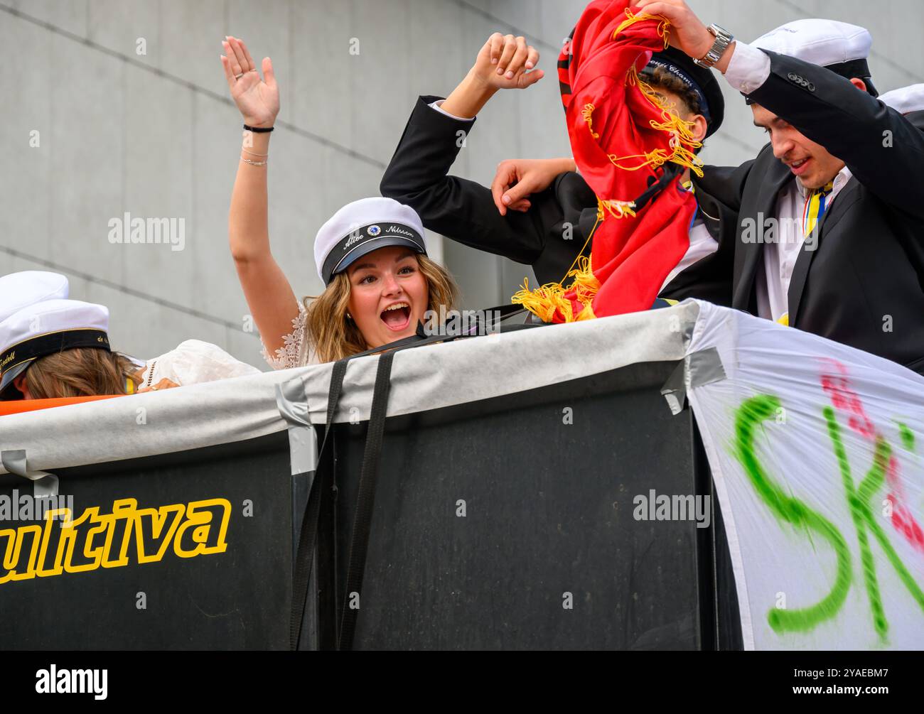 A group of exuberant students proudly celebrates graduation during a ...