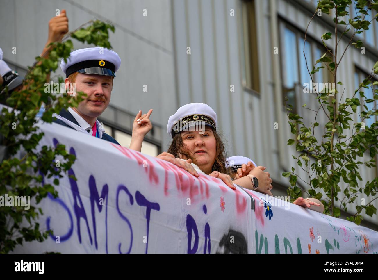 A group of exuberant students proudly celebrates graduation during a ...