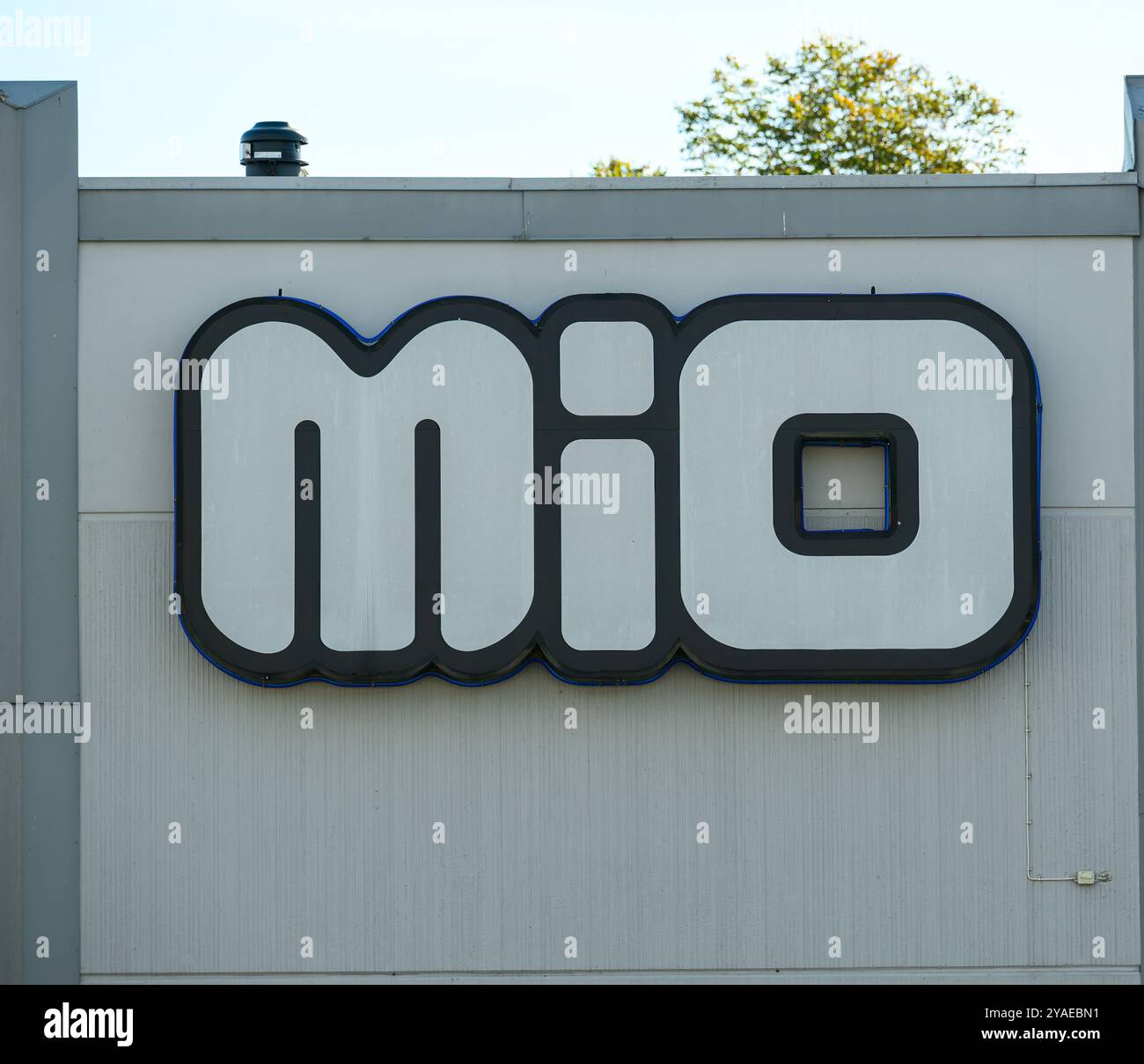 The bold letters of the sign spelling MIO stand out against the ...