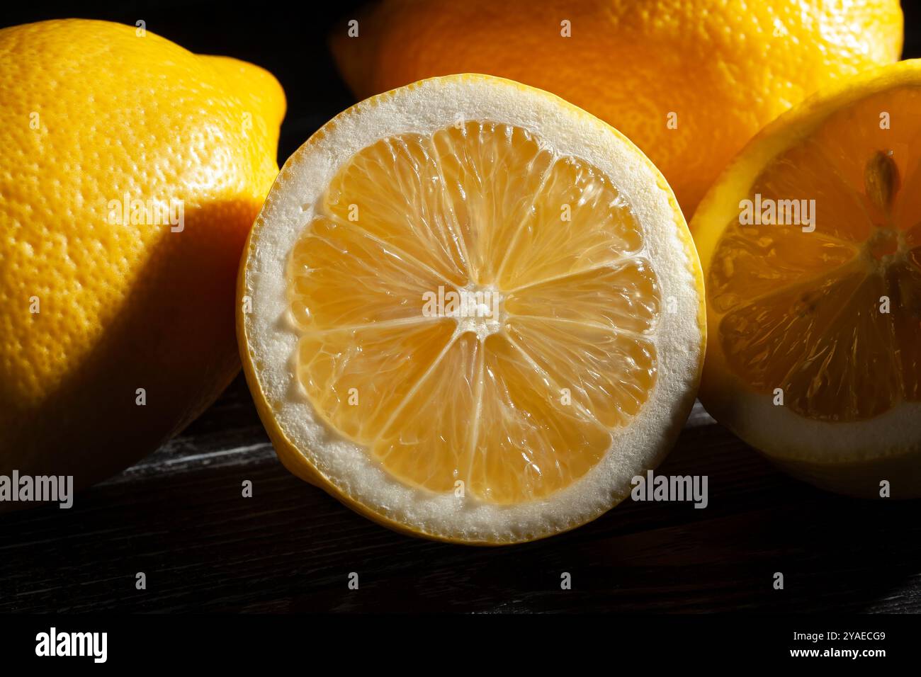 Half cut sliced fresh lemon on wood hi-res stock photography and images ...