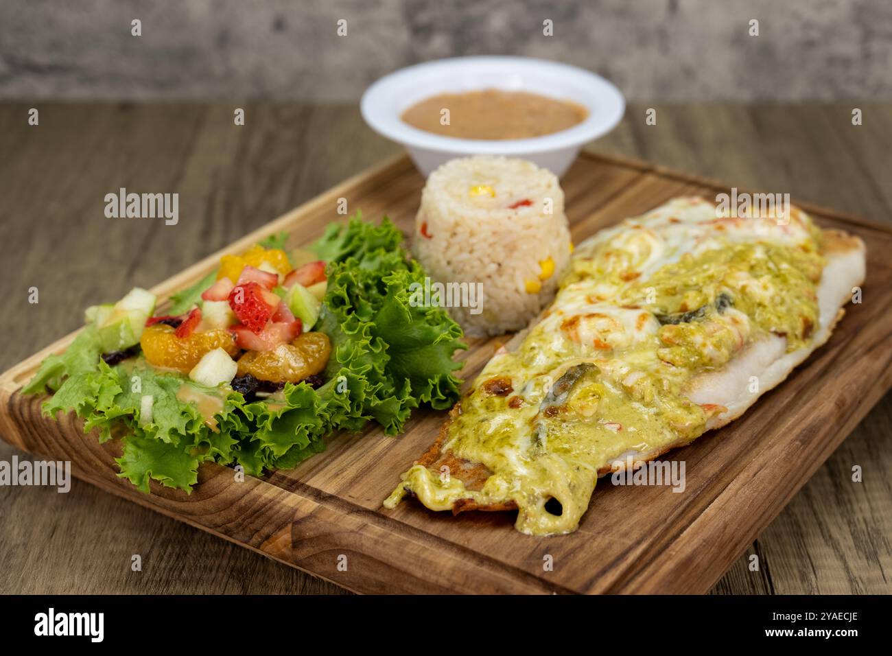 Grilled Basa fish fillet smothered in gratinado cheese dinner served ...