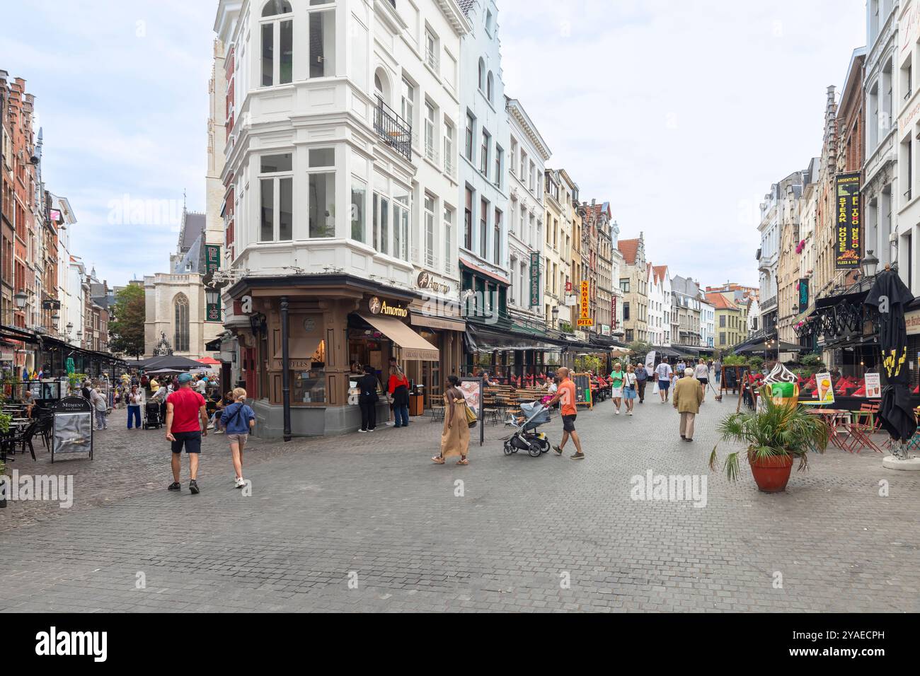People walk through the pleasant shopping streets in the city center of ...