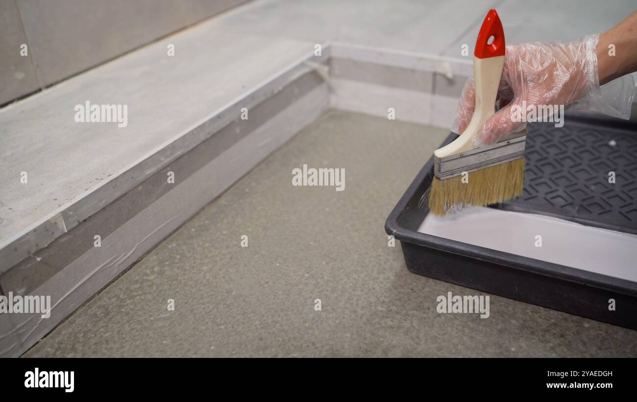 Construction worker picking up waterproofing material with brush Stock ...
