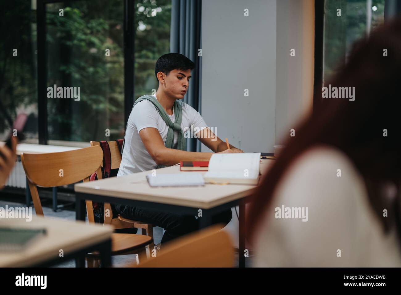 Focused student studying in a classroom during daylight Stock Photo - Alamy