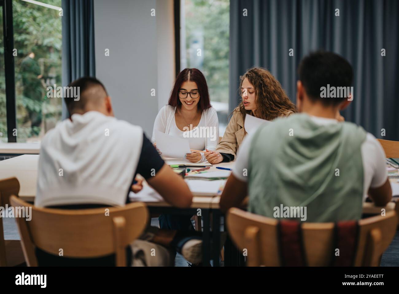 People around table books hi-res stock photography and images - Alamy