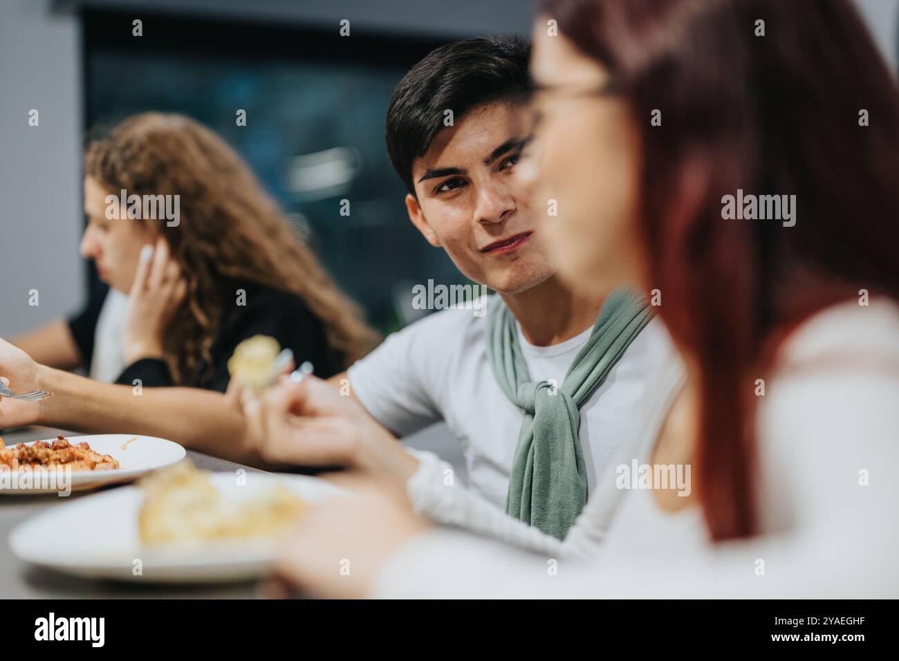 Group of students enjoying a lively conversation and meal together in a ...