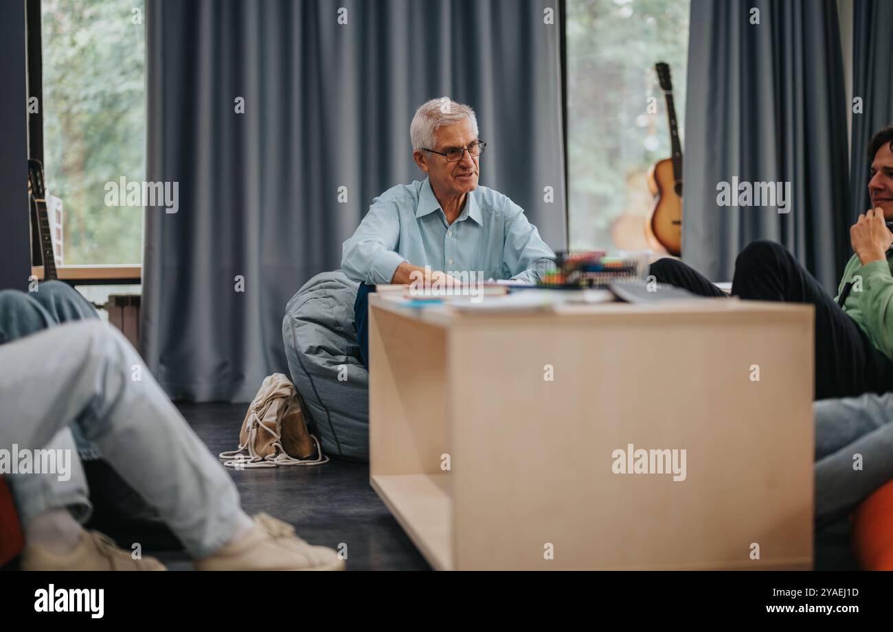 Professor engaging with students in a relaxed classroom setting Stock ...