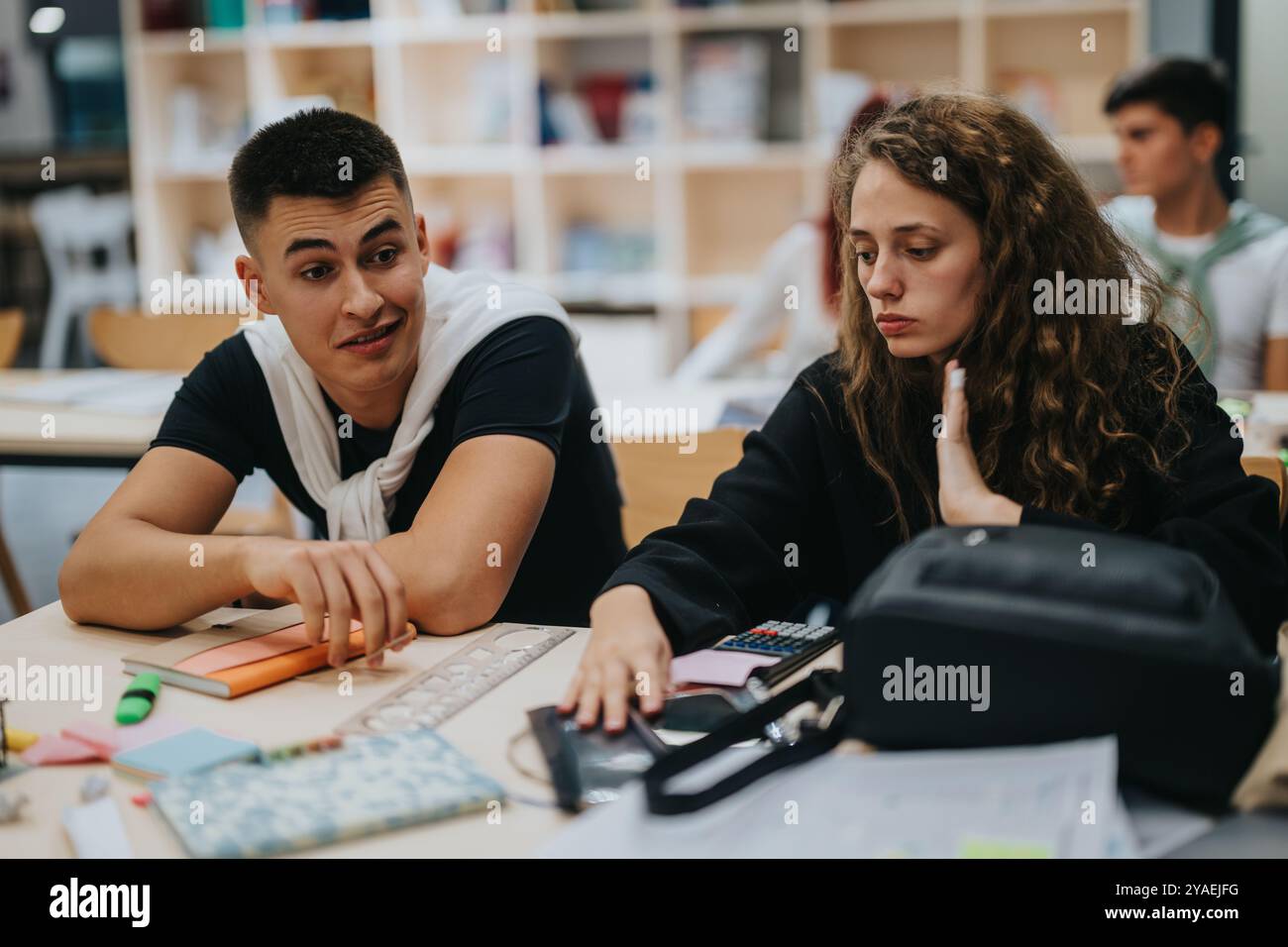 Students collaborating in a classroom with focused engagement Stock Photo - Alamy
