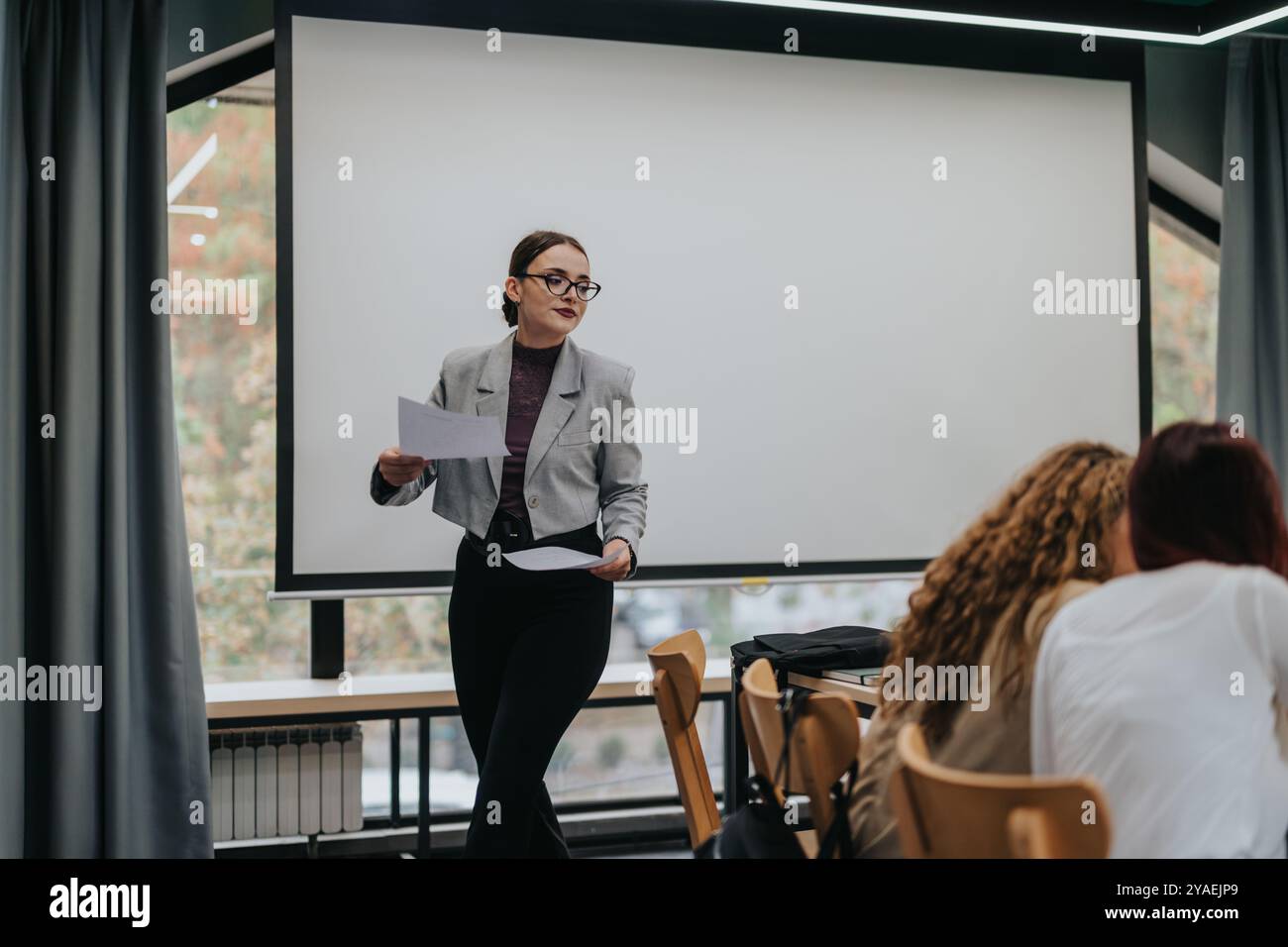 Female teacher presenting students in hi-res stock photography and ...