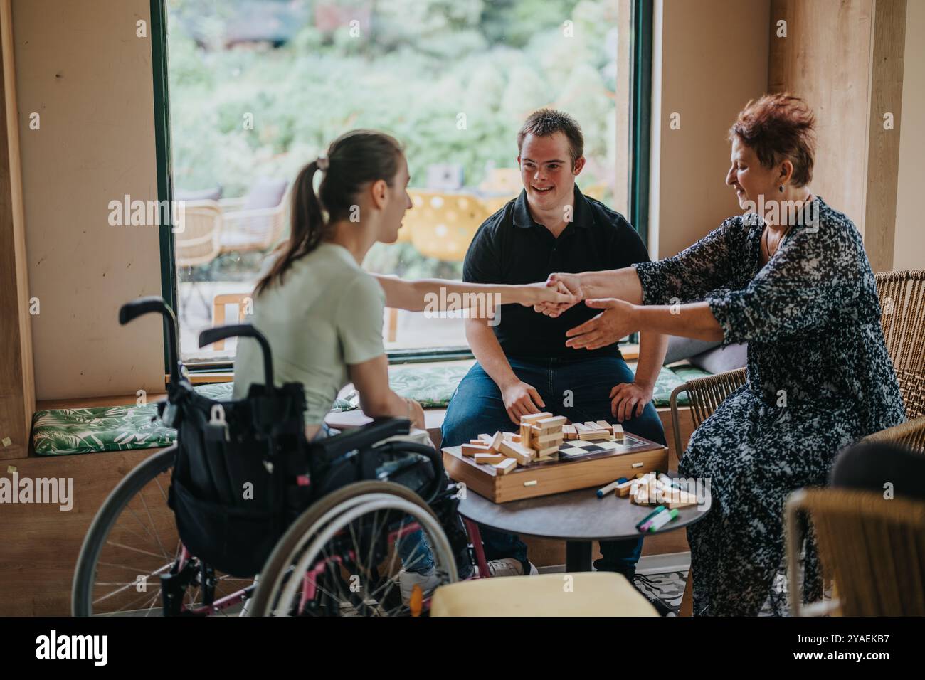 Boy with Down syndrome and girl in wheelchair playing blocks game Stock ...