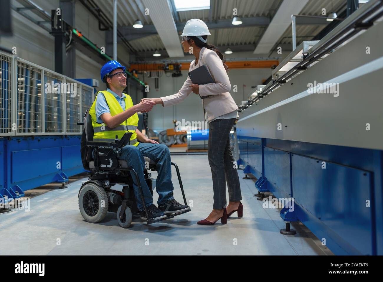 Indian woman, a production manager, shaking hands to employee with a ...