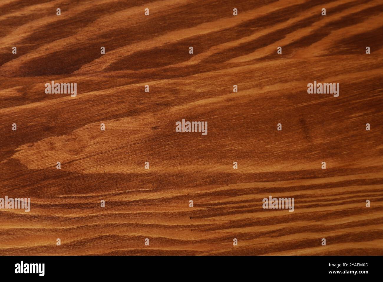 Applying walnut wood stain. Texture of wooden surface as background ...