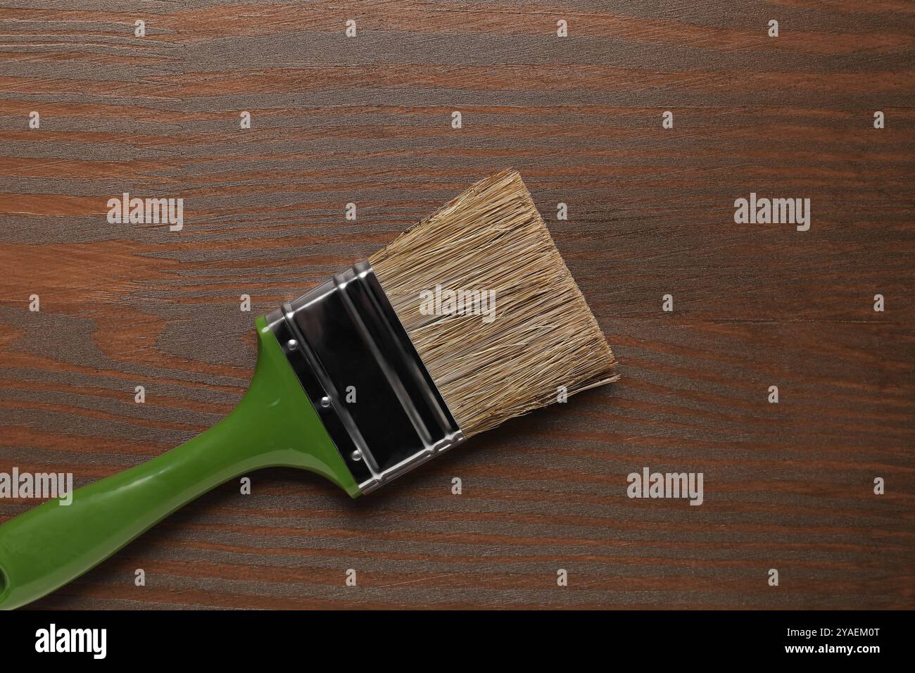 Applying walnut wood stain. Brush on wooden surface, top view Stock ...