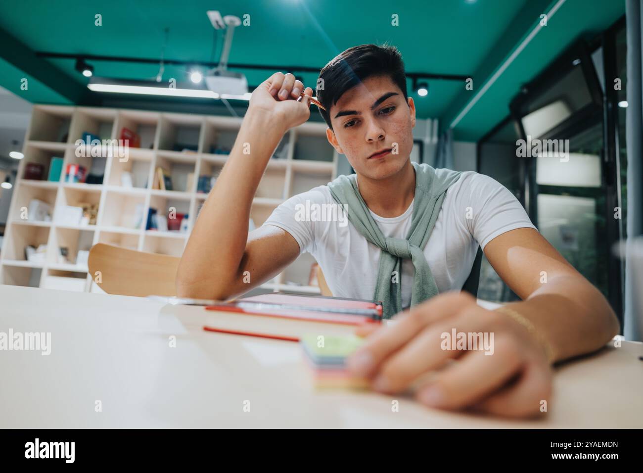 Focused student studying in a modern classroom setting Stock Photo - Alamy