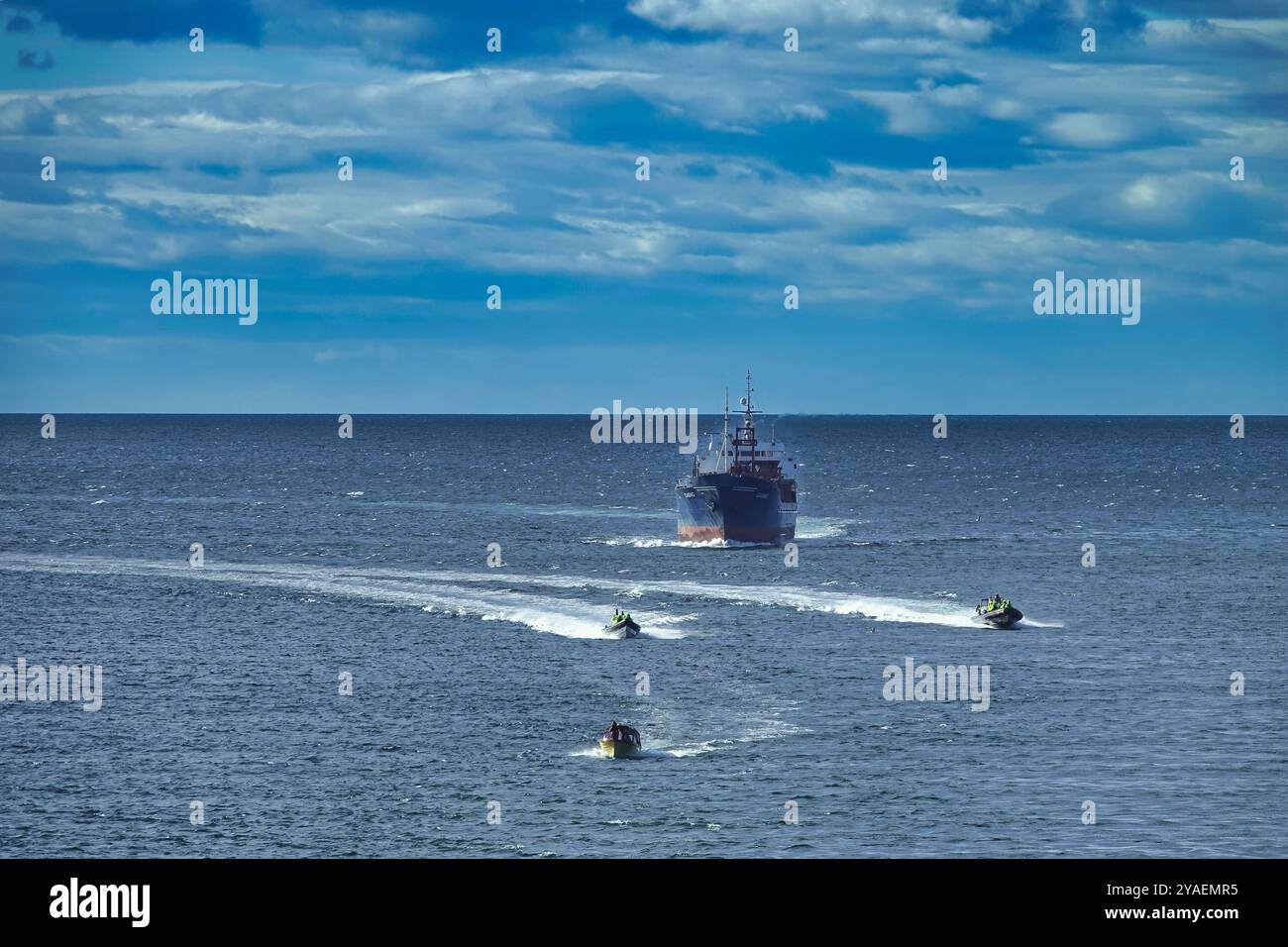 Bodo, Norway, 12th September,2024 Fishing boat follows behind three ...