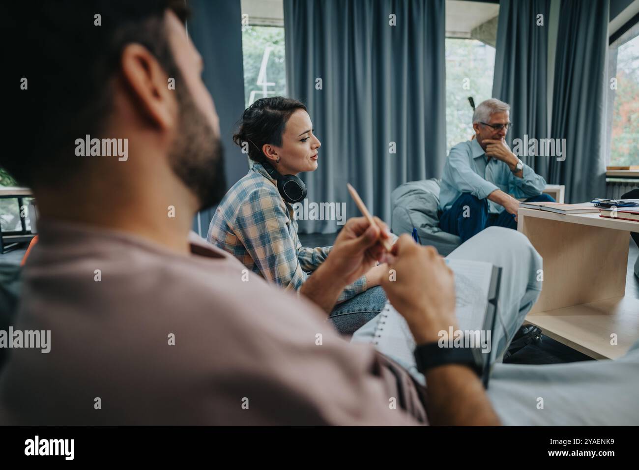 Professor engaging with students in a casual classroom setting Stock ...