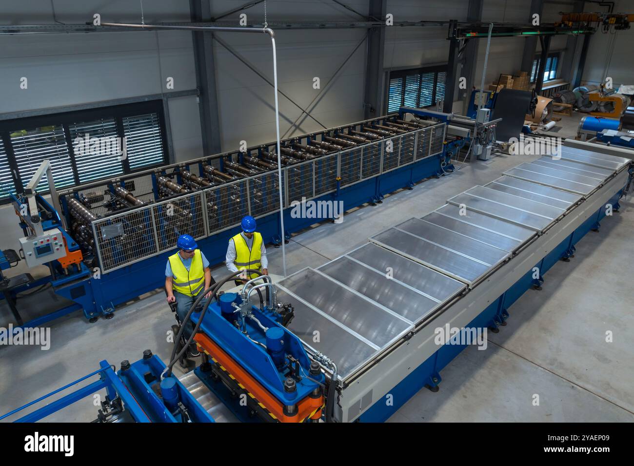 Engineer team, African American man and one with disability manually controlling automated ...