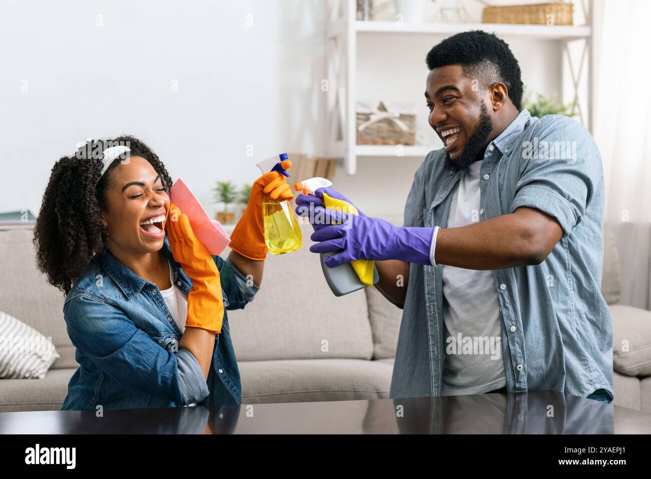 Happy Housekeeping. Cheerful black couple having fun while doing ...