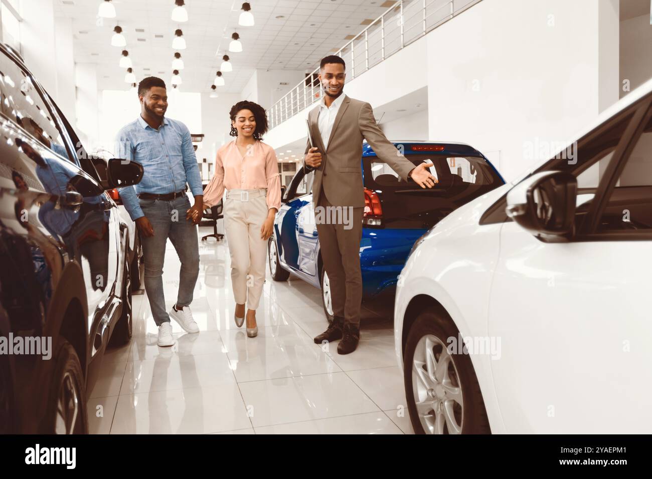 Seller Showing Luxury Car Consulting Couple In Dealership Shop Stock ...