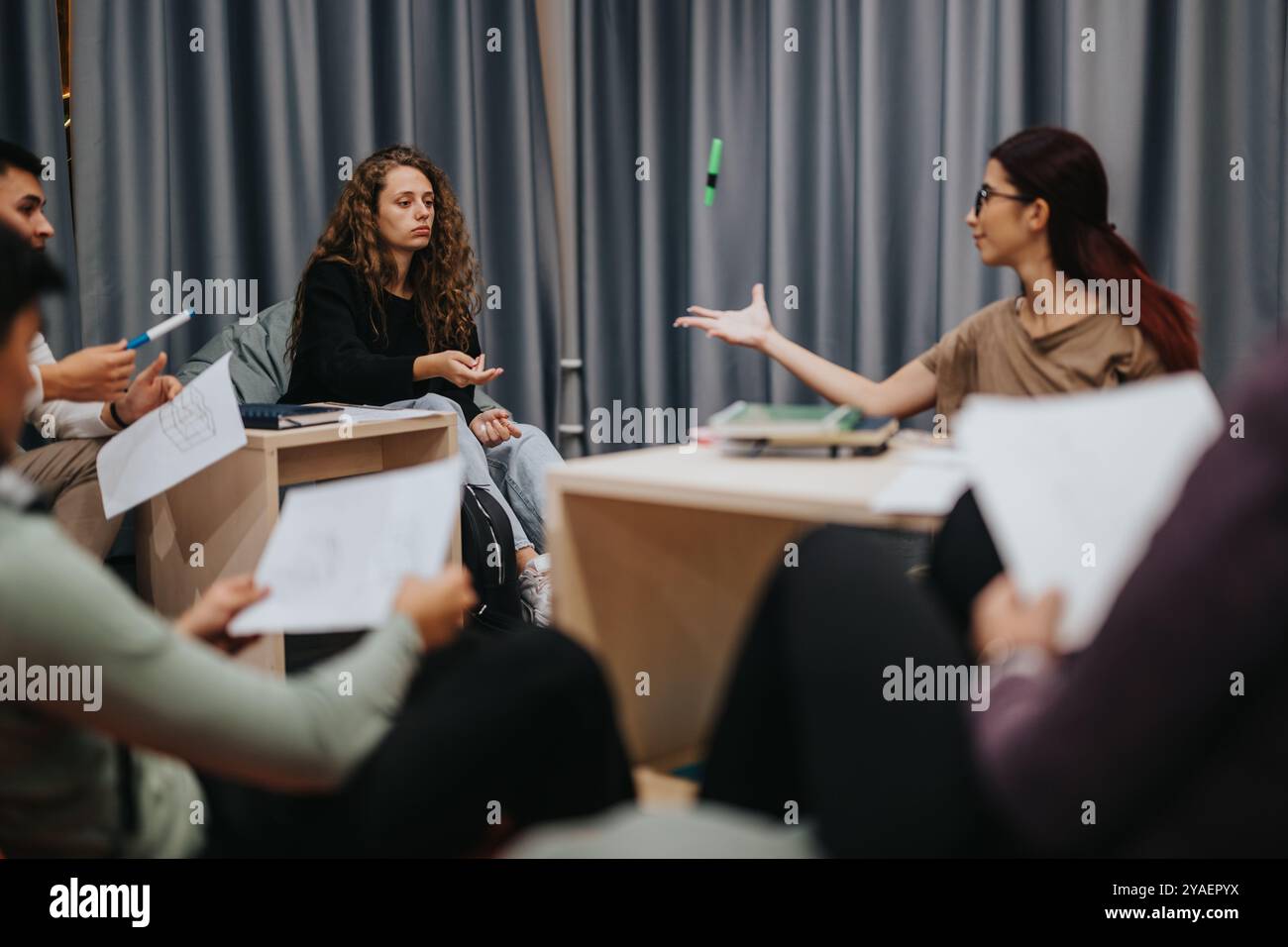 Students engaged in a collaborative classroom setting, discussing ideas and exchanging knowledge ...