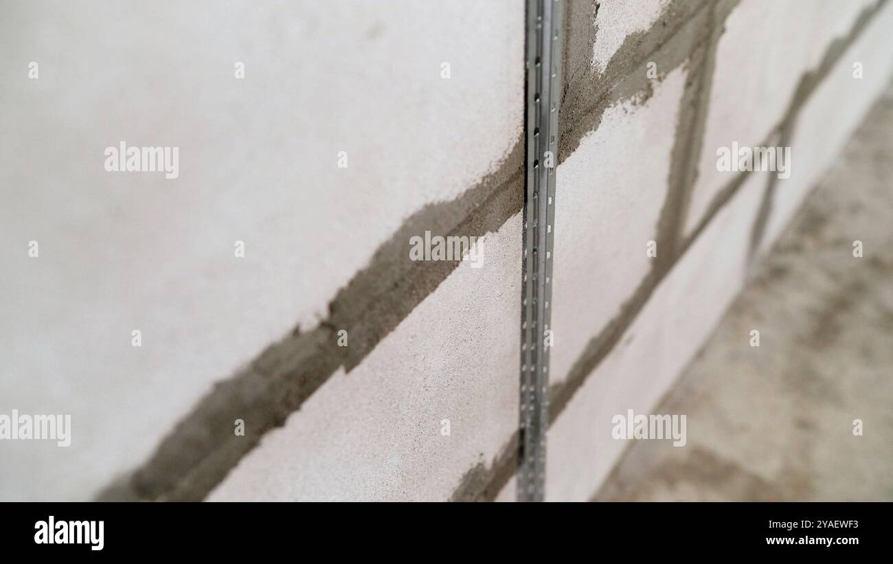 Metal profile fixing to aerated concrete wall using screws Stock Photo ...