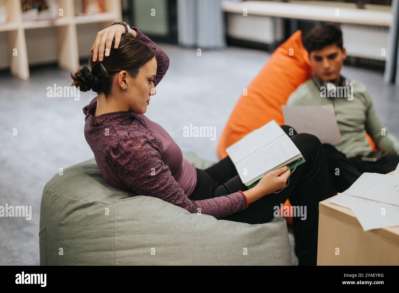 Students studying together in a relaxed school environment focused on ...